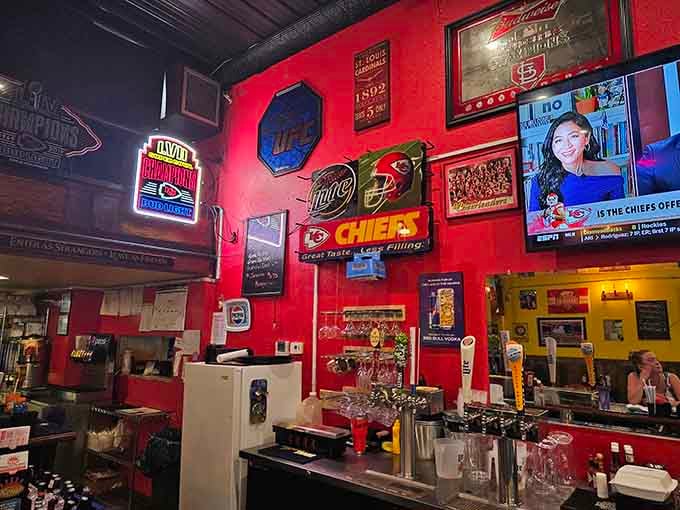 Chiefs pride meets vintage beer signs on walls that celebrate both sports legends and cold refreshments equally well.
