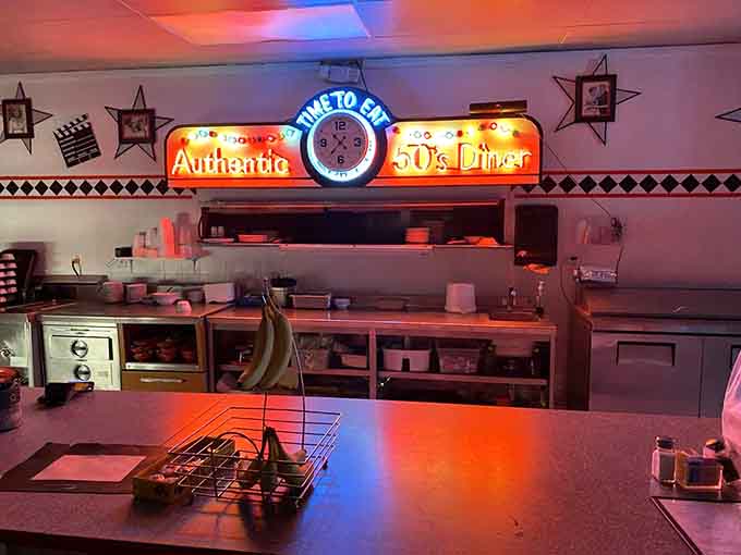 The counter view reveals neon signs and a soda shop atmosphere where watching the kitchen magic happens is half the fun.