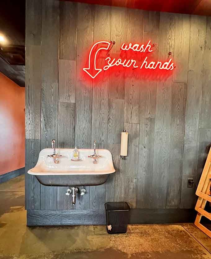 A neon reminder that great barbecue requires getting your hands dirty, and that's perfectly acceptable here.