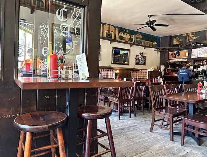 Cozy seating with plaid curtains create intimate dining nooks perfect for burger-induced food comas and conversation.