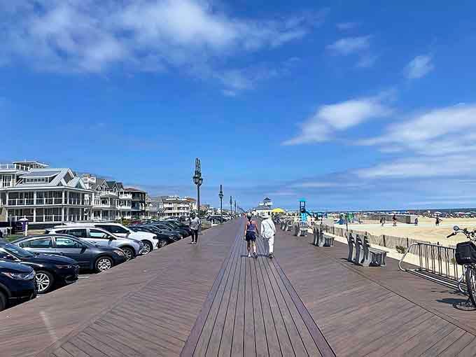 The boardwalk stretches toward sandy beaches where the smell of fresh seafood mingles perfectly with salty ocean air.