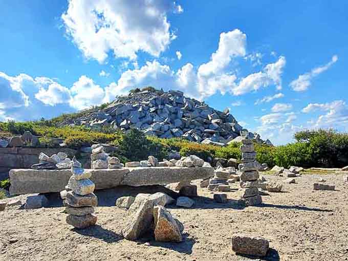 Stacked stone cairns and a granite gravel pile under big Cape Ann skies &mdash; Halibut Point's rugged charm.