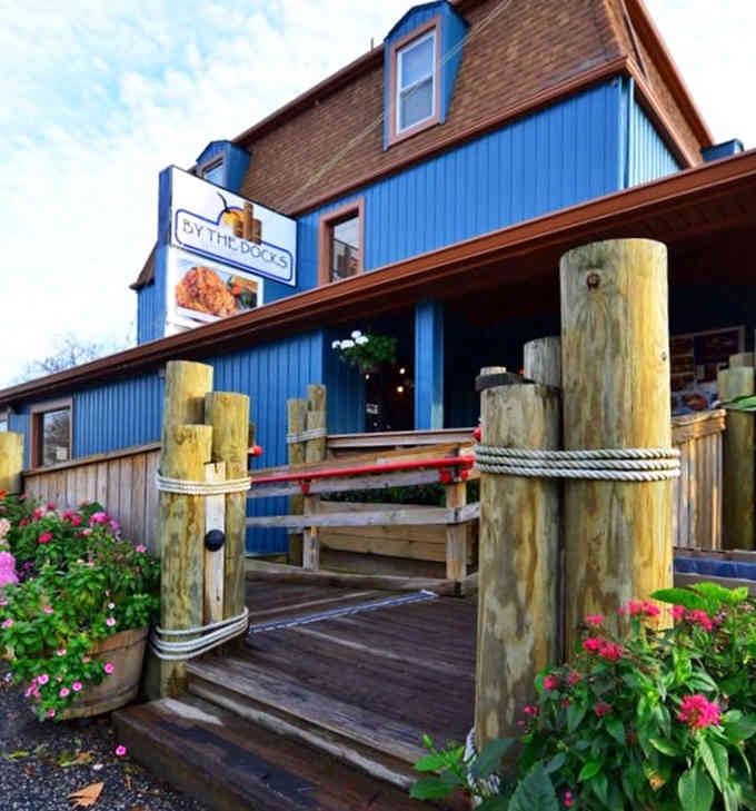 Weathered dock pilings wrapped in rope signal authentic waterfront dining where the crab cakes are as real as it gets.