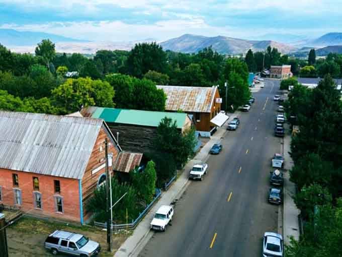 Mountains peek through the trees along a street where the pace of life is measured in friendly conversations, not minutes.