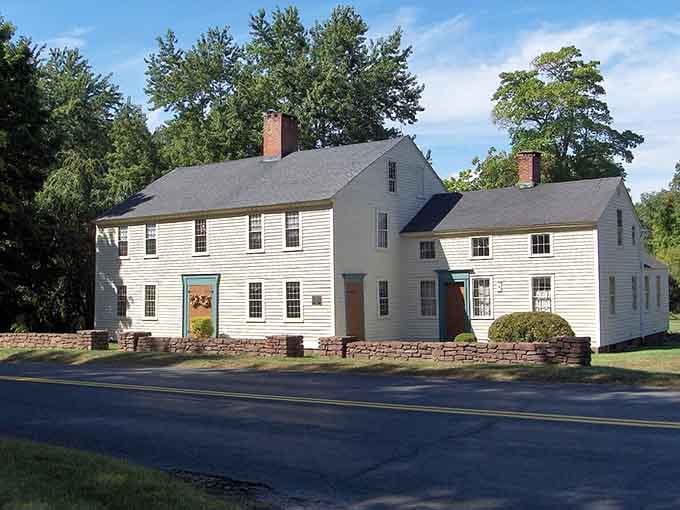 This colonial homestead with its white clapboard siding stands as a testament to enduring New England craftsmanship.