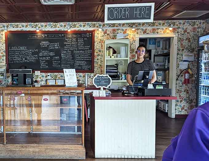 The order counter where dreams begin and diets end, staffed by folks who understand pie is serious business.