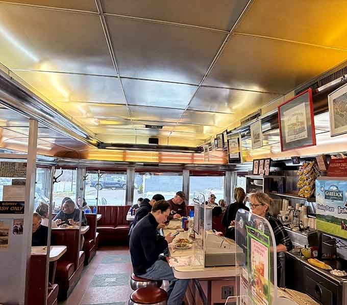 Real diners eating real food in a real diner, no filters needed, just pure breakfast satisfaction in action.