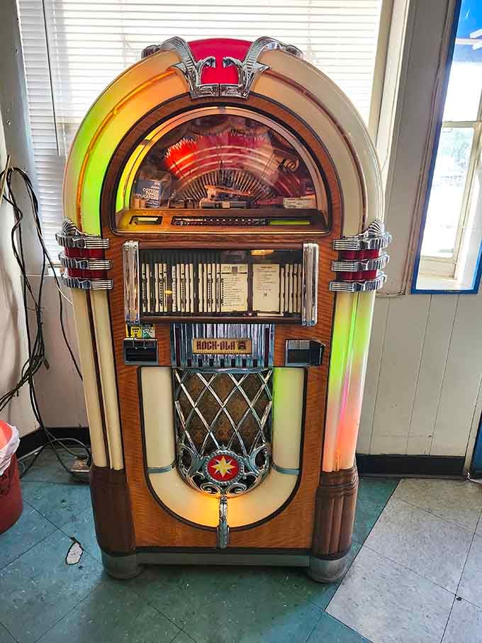 A classic jukebox stands ready to soundtrack your meal with tunes from decades past, pure nostalgic magic.
