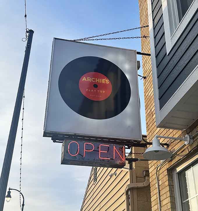 That vinyl record sign spinning outside tells you everything: this place takes its food seriously and fun seriously.