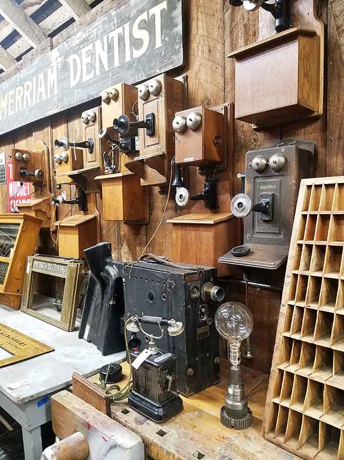 Antique telephones hang beside vintage tools, creating a wall of nostalgia that would make any history buff's heart skip.