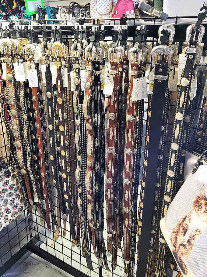 Belts hanging like leather curtains, ready to hold up pants and complete outfits for bargain hunters everywhere.