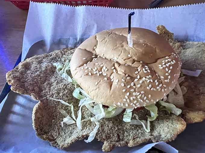 That giant breaded tenderloin sandwich looks like it's trying to escape the bun, bless its heart.