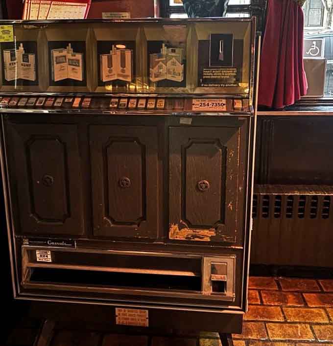 An old cigarette machine stands as a nostalgic reminder of when restaurants had ashtrays instead of charging stations.