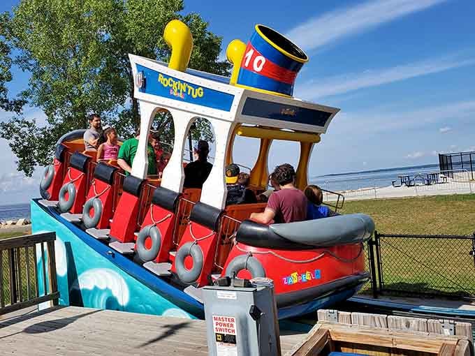 This cheerful tugboat ride rocks passengers back and forth, proving that nautical adventures don't require actual water to be entertaining.