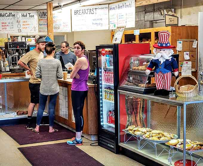 The universal language of pointing at donuts through glass transcends all barriers, bringing people together in sugary harmony.