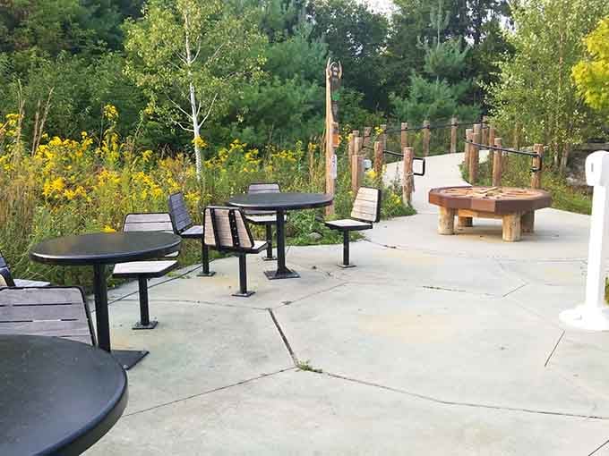 Picnic tables positioned perfectly for parents who've mastered the art of relaxing while maintaining constant visual surveillance of their offspring.