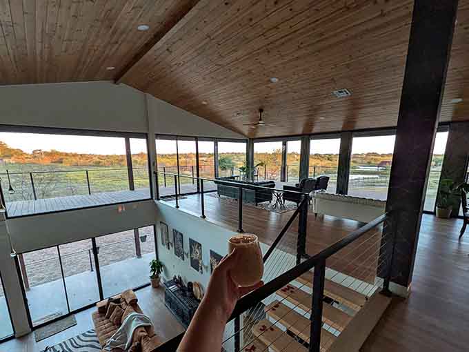 Wraparound windows on the upper level offer panoramic views where every direction reveals another reason you never want to leave.