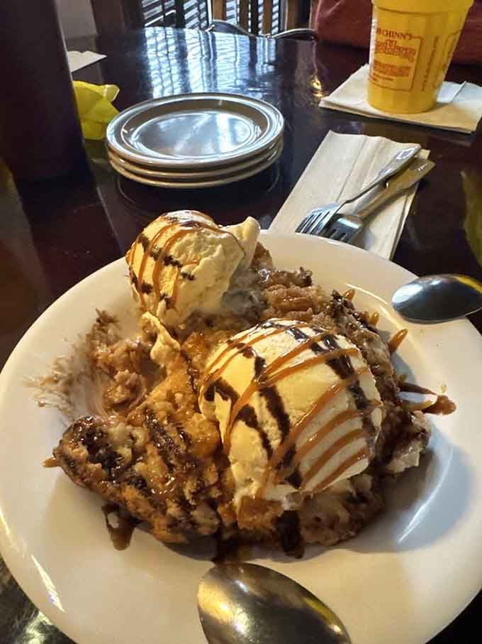Ice cream and chocolate sauce cascading over what appears to be heaven disguised as dessert, worth every calorie.
