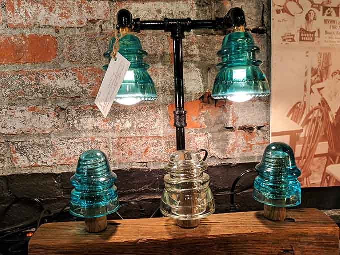 Someone turned vintage glass insulators into a lamp, because why shouldn't your lighting have a previous career on telephone poles?