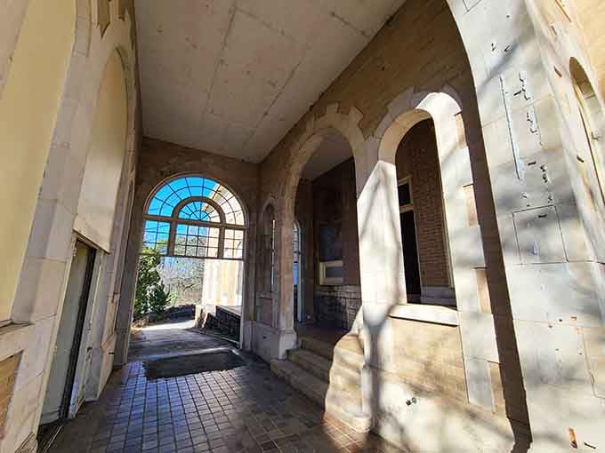 Arched entryway with sunlight streaming through demonstrates how architecture can create pure magic with simple geometry.
