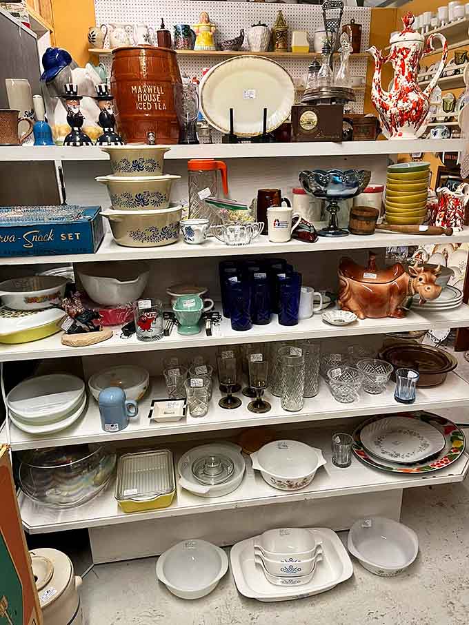 Maxwell House barrels, Pyrex bowls, and carnival glass create a kitchen collection spanning seven decades of American home cooking traditions.