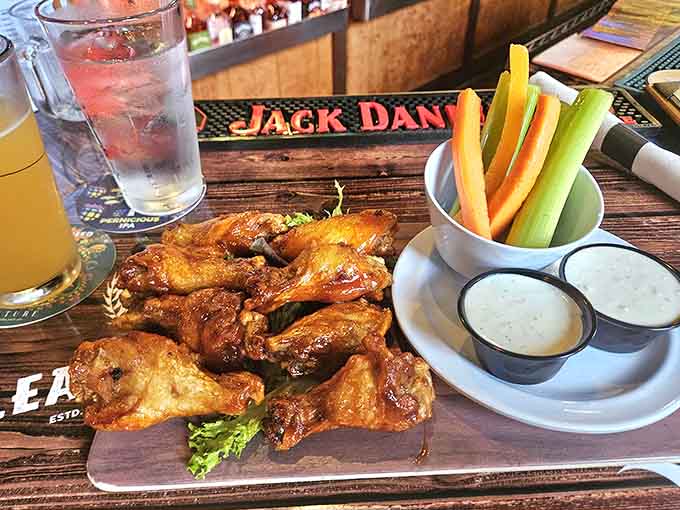 Wings glistening with sauce arrive with celery and carrot sticks, the vegetables providing adorable moral support for the main event.