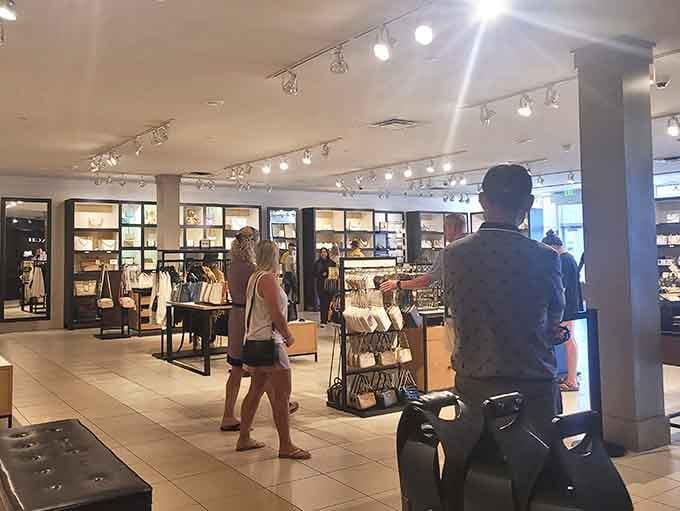 Shoppers browse displays in bright, welcoming spaces where finding deals feels less like hunting and more like discovering.