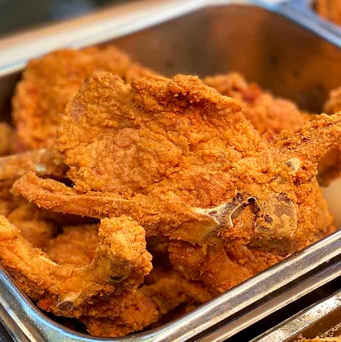 Those pork chops have achieved the perfect golden-brown crust that dreams are made of, seriously.