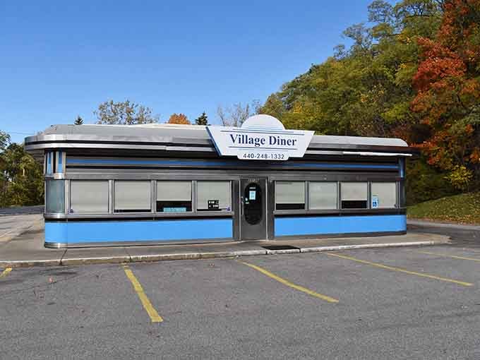 The Village Diner's classic chrome-and-blue exterior is a love letter to every road trip you took before GPS existed.