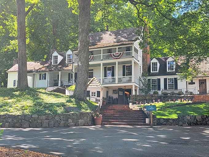 Michie Tavern ca. 1784 sits quietly beneath ancient trees, carrying centuries of Virginia history in every weathered plank and welcoming porch.