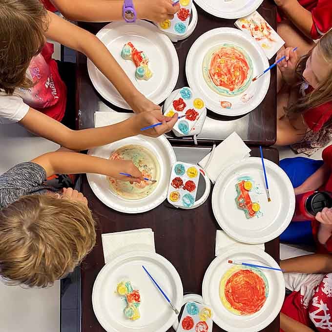 Kids creating chocolate art with more focus than their homework ever receives, and honestly, who can blame them?
