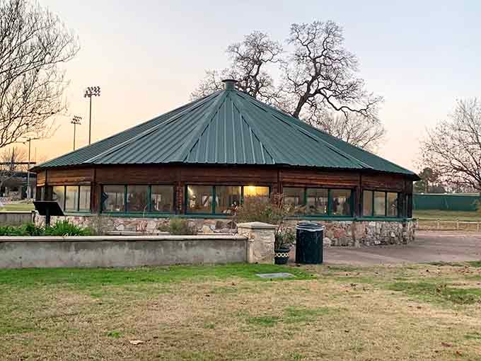 The pavilion sits peacefully in the park, looking like it's been there forever and belongs exactly there.
