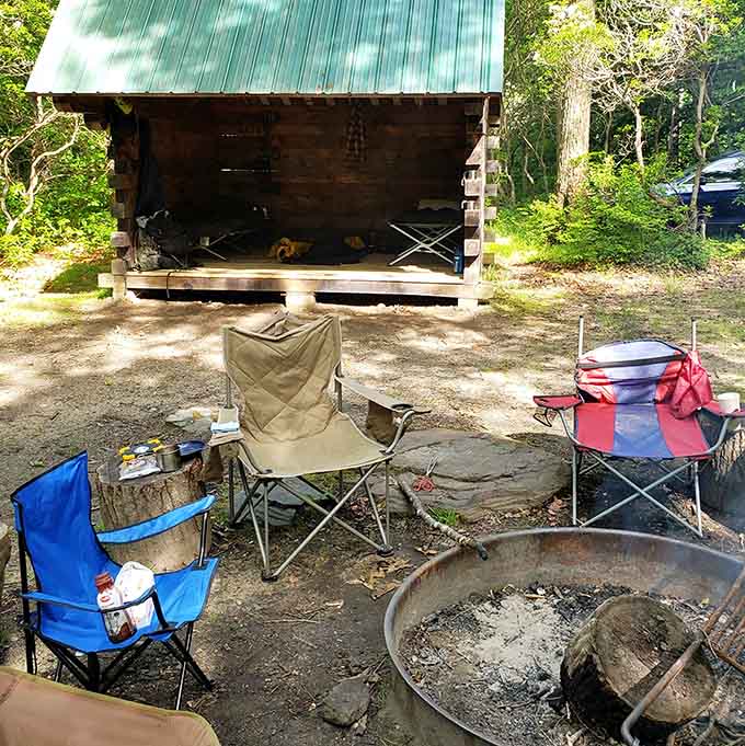 Rustic camping setups around the fire ring offer authentic outdoor experiences minus the luxury hotel amenities.