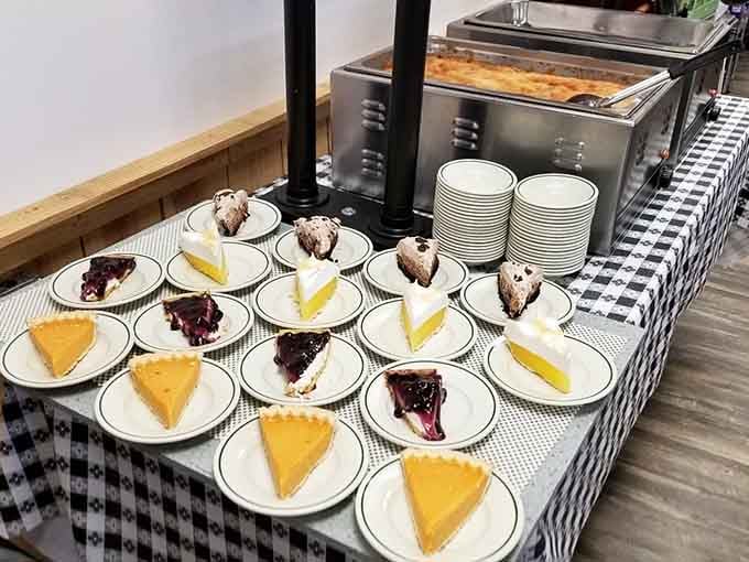 Pre-sliced pies lined up like edible soldiers, each one a sweet ending to your savory buffet marathon experience.