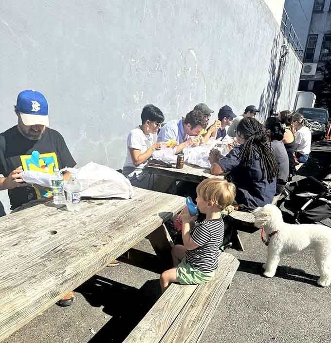 Picnic tables, good sandwiches, happy people, and one very lucky dog. This is what a perfect lunch looks like.