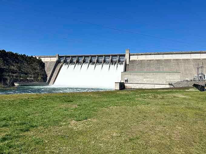 The massive dam holds back billions of gallons while releasing just enough to keep trout fishermen very happy.