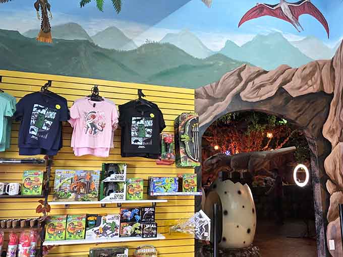 The gift shop entrance beckons through a cave because shopping for dinosaur souvenirs should feel appropriately adventurous.