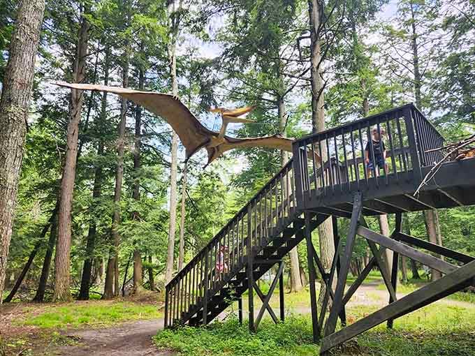 A Pterosaur perches above the walkway, reminding visitors that prehistoric life conquered land, sea, and sky alike.