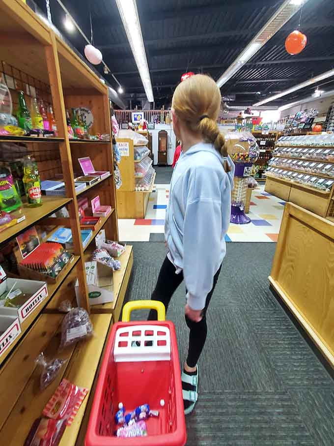 She's shopping with purpose and determination, clearly someone who knows exactly what her candy mission requires today.