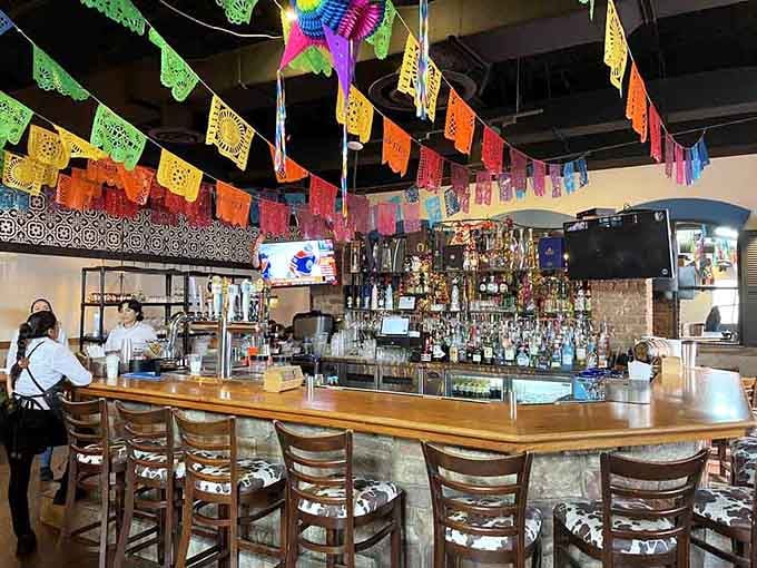 A well-stocked bar backed by colorful banners suggests this establishment takes both food and beverages seriously.