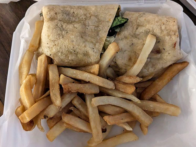 Greek wrap stuffed with goodness and served with hot fries proves simple ingredients can create something memorable.