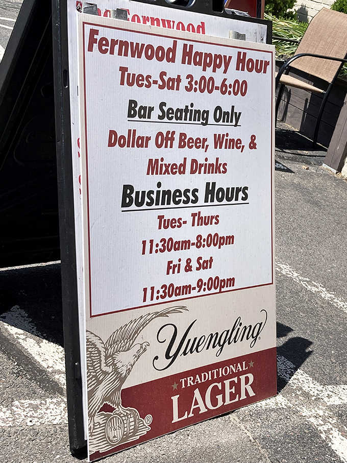 Happy hour specials and business hours posted outside, because good planning leads to great meals and cold drinks.