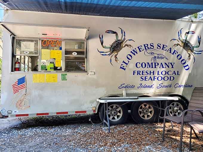 The ordering trailer decorated with blue crabs shows this operation takes local seafood seriously, from boat to window.