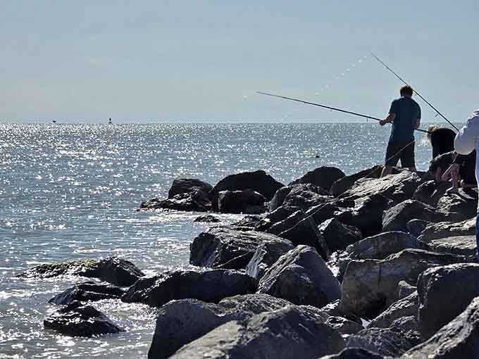 Fishing from the rocks beats any office view, especially when tarpon are running through the pass.