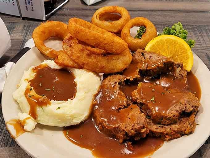 Meatloaf, mashed potatoes, and onion rings form the holy trinity of comfort food that never goes out of style.