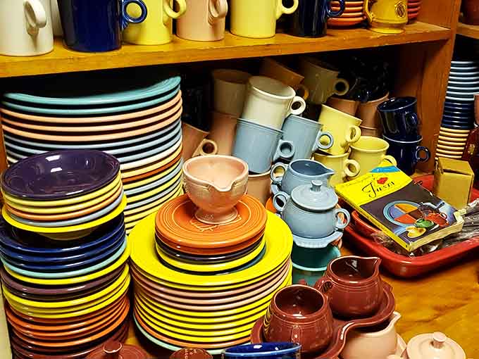 Fiestaware stacked in rainbow towers, because apparently our ancestors understood that dishes should spark joy before Marie Kondo trademarked it.