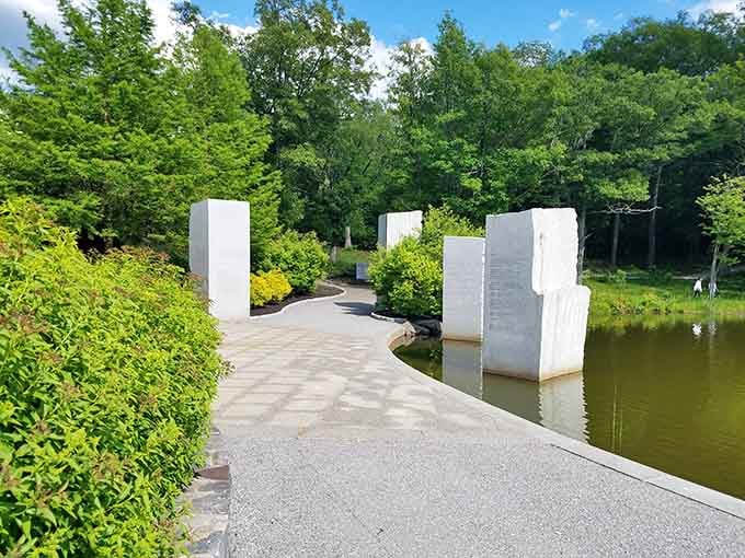 Modern memorial stones rising from the water create a contemplative space that's both artistic and meaningful for quiet reflection moments.