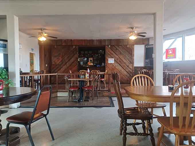Step inside to find mismatched chairs and wood paneling that feel authentically lived-in, not decorator-designed rustic.