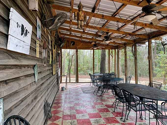 The screened patio offers outdoor dining surrounded by woods, perfect for those who want their Lizard Man experience al fresco style.