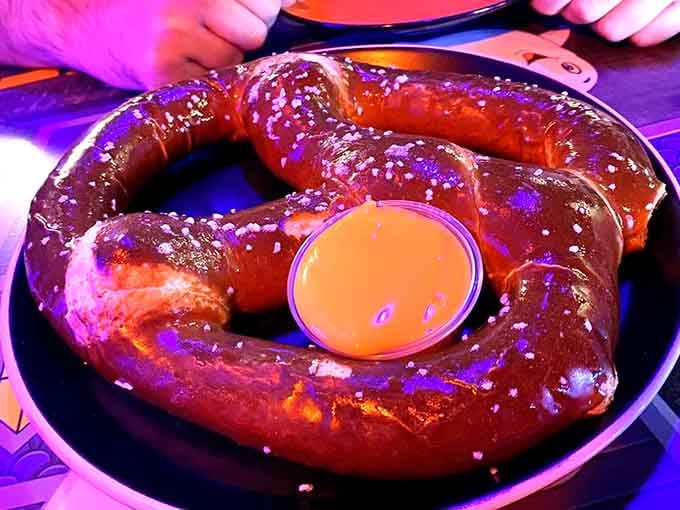 The Jack O' Lantern Jumbo Pretzel arrives as one massive twisted creation, salted and ready for serious dipping action ahead.